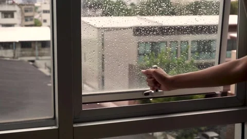 Woman opening window after rain, roof of... | Stock Video | Pond5