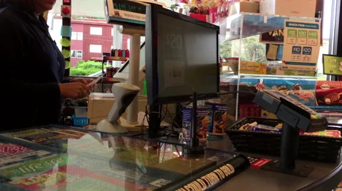Woman buying lotto ticket at check out c. Stock Video Pond5