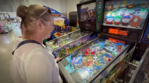 Woman playing pinball inside the pinball... | Stock Video | Pond5