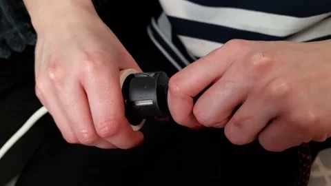 Woman plugging black plug in extension c... | Stock Video | Pond5