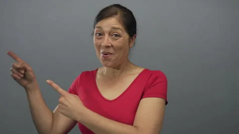 Woman pointing finger in grey studio env... | Stock Video | Pond5