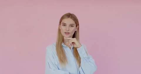 Woman pointing upwards, looking at camer... | Stock Video | Pond5