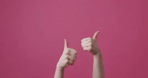 Woman points thumb up against an isolate... | Stock Video | Pond5
