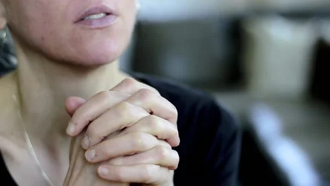 woman praying with hand over her face on... | Stock Video | Pond5