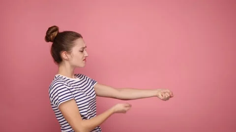 Woman pulling invisible rope with effort... | Stock Video | Pond5