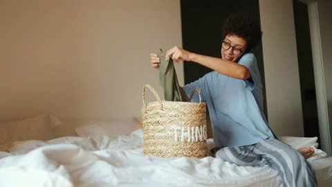Woman pulling things out of laundry bask... | Stock Video | Pond5