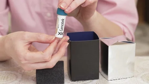 woman puts a saliva container for dna te... | Stock Video | Pond5