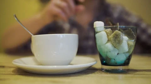 Woman putting sugar into tea cup using t... | Stock Video | Pond5