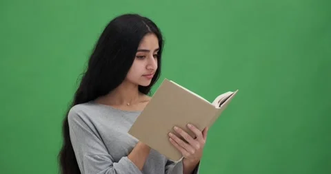 Woman reading a book on green screen | Stock Video | Pond5