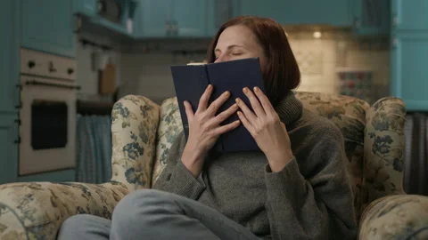 Woman Reading Paper Book. 30s female sme... | Stock Video | Pond5