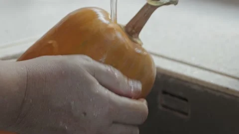 Woman rinsing pumpkin in the sink. Healt... | Stock Video | Pond5