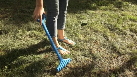 Woman running a blue rake close-up shot | Stock Video | Pond5
