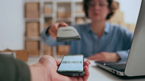 A woman scans a barcode on a smartphone ... | Stock Video | Pond5