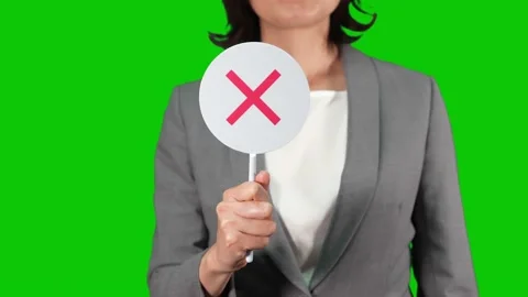 Woman showing a cross sign plate. Green ... | Stock Video | Pond5