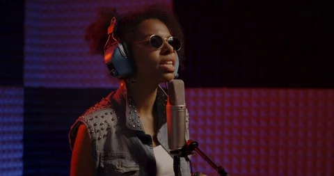 Woman singing in recording booth | Stock Video | Pond5