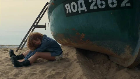 Woman sitting bending body to legs empty... | Stock Video | Pond5