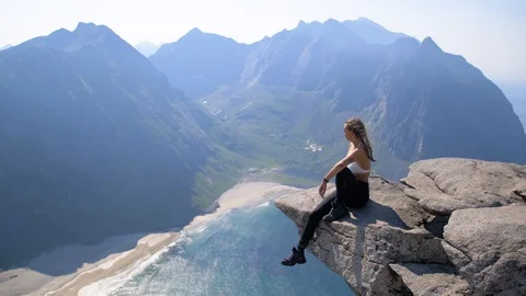 Woman sitting on a ledge overlooking the... | Stock Video | Pond5