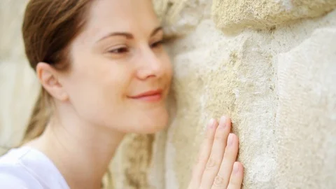 Woman sliding hand against old stone wal... | Stock Video | Pond5