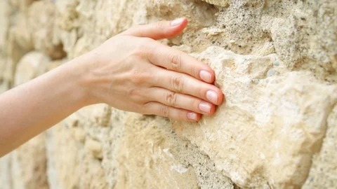 Woman sliding hand against old stone wal... | Stock Video | Pond5