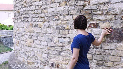 Woman sliding hand against old ancient s... | Stock Video | Pond5