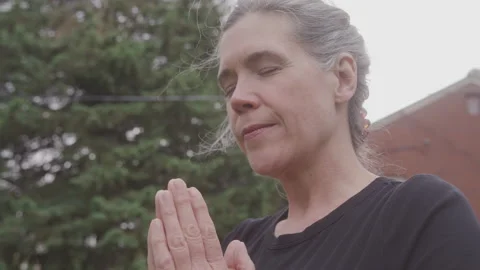 Woman Stands Outside with Praying Hands ... | Stock Video | Pond5