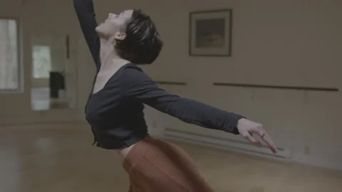 Woman Stretches Back In Dance Studio | Stock Video | Pond5