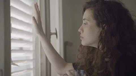 Woman stuck indoors with sad face puts h... | Stock Video | Pond5