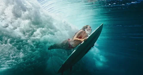 Woman Surfer Diving Under Ocean Wave | Stock Video | Pond5