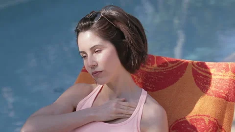 Woman at swimming pool applying sunscree... | Stock Video | Pond5