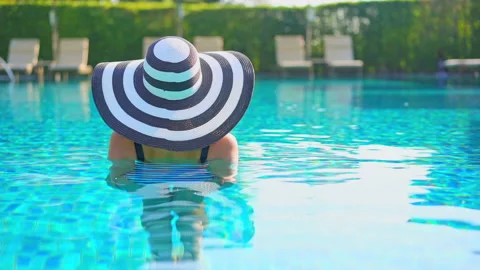 A woman in a swimming pool wearing a hug... | Stock Video | Pond5