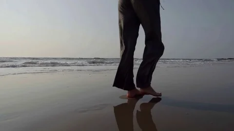 Woman takes slow relaxing walk on the be... | Stock Video | Pond5