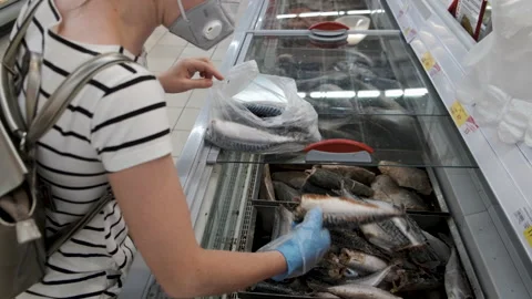 woman taking a fish in store. woman shop... | Stock Video | Pond5