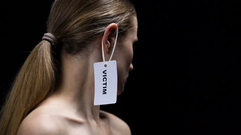 Woman taking off victim label from ear, ... | Stock Video | Pond5