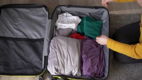 Woman unpack suitcase for vacation at ho... | Stock Video | Pond5