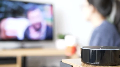 Woman Uses Smart Device To Turn Off TV A... | Stock Video | Pond5