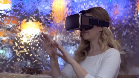 woman uses a virtual reality glasses on ... | Stock Video | Pond5