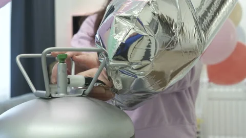 Woman using helium tank blowing up ballo... | Stock Video | Pond5