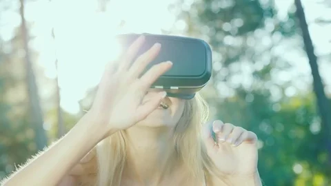 Woman in VR helmet. In the sun, beautifu... | Stock Video | Pond5