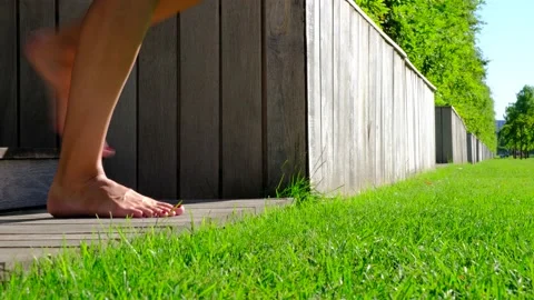 Woman walk bare feet, through a green la... | Stock Video | Pond5
