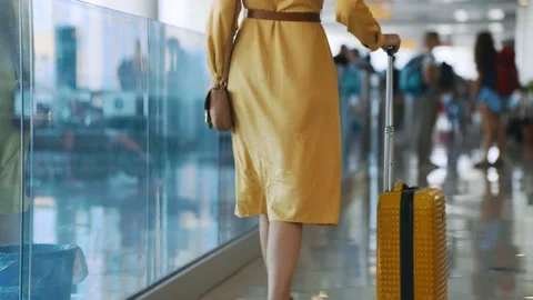 Woman walking in airport terminal. Back ... | Stock Video | Pond5