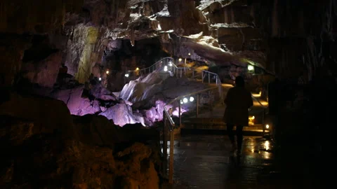 A woman walking along a pathway inside a... | Stock Video | Pond5