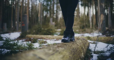 Woman Walking on Tree Trunk in Forest | Stock Video | Pond5