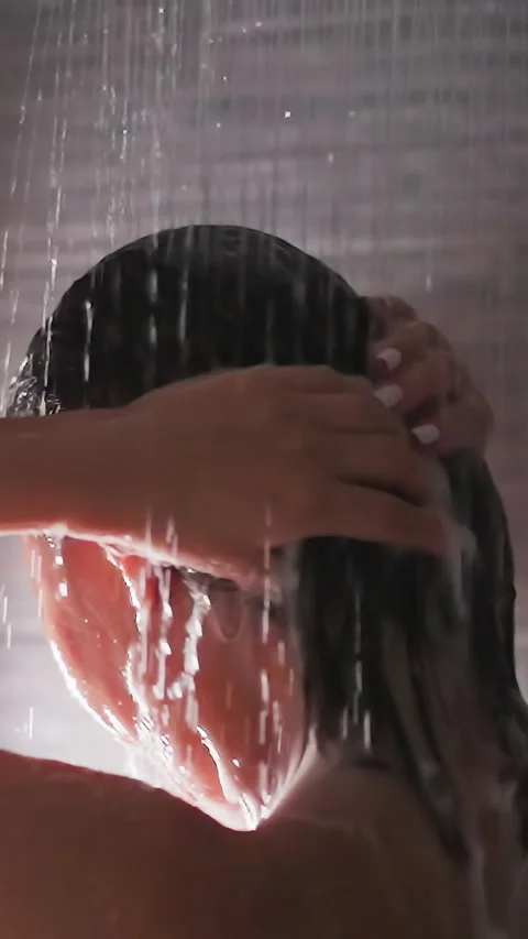 Woman washes hair under shower sprays cl... | Stock Video | Pond5