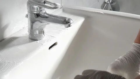 A woman washes the sink in the bathroom.... | Stock Video | Pond5