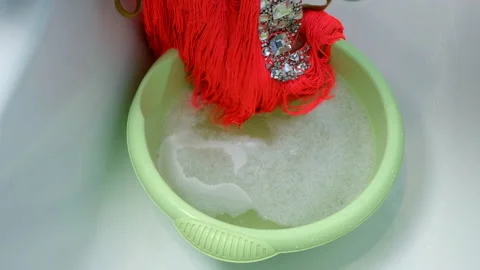 Woman is washing dance dress in basin in... | Stock Video | Pond5