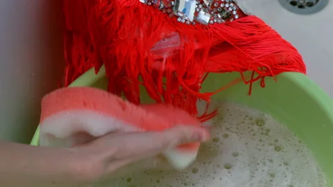 Woman is washing dance dress in basin in... | Stock Video | Pond5
