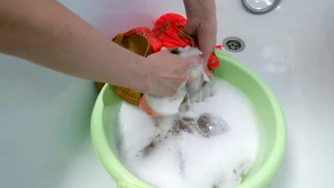 Woman is washing dance dress in basin in... | Stock Video | Pond5