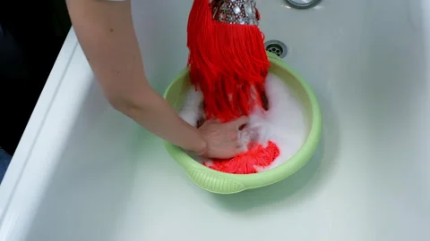 Woman is washing dance dress in basin in... | Stock Video | Pond5