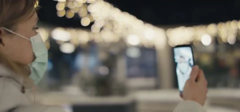 Woman wears a mask video calls looks Chr... | Stock Video | Pond5