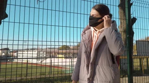 Woman wears protective face mask and loo... | Stock Video | Pond5